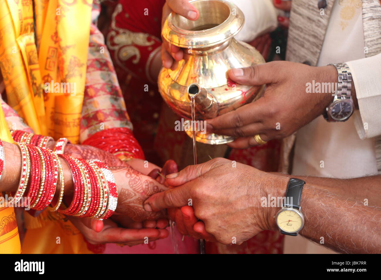wedding ceremony family giving hand to to bright groom Stock Photo - Alamy