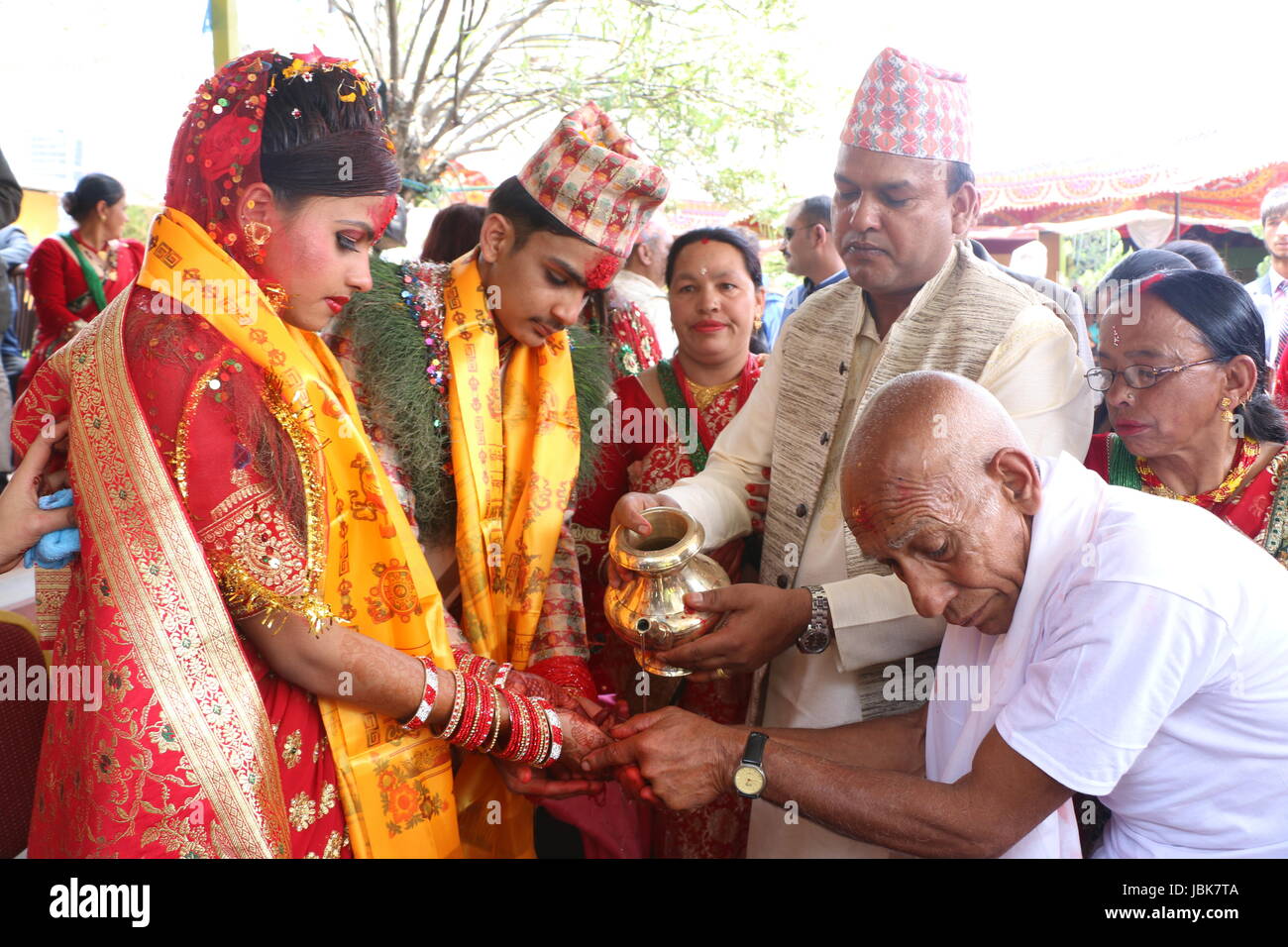 wedding ceremony family giving hand to to bright groom Stock Photo - Alamy