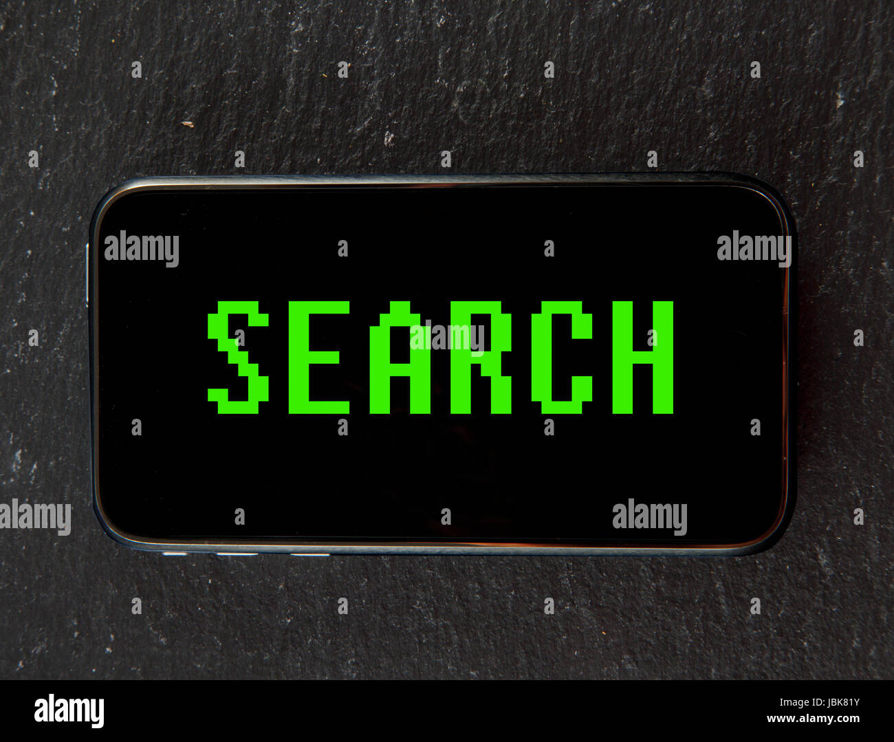 Smartphone with text "Search" in vintage computer font Stock Photo - Alamy