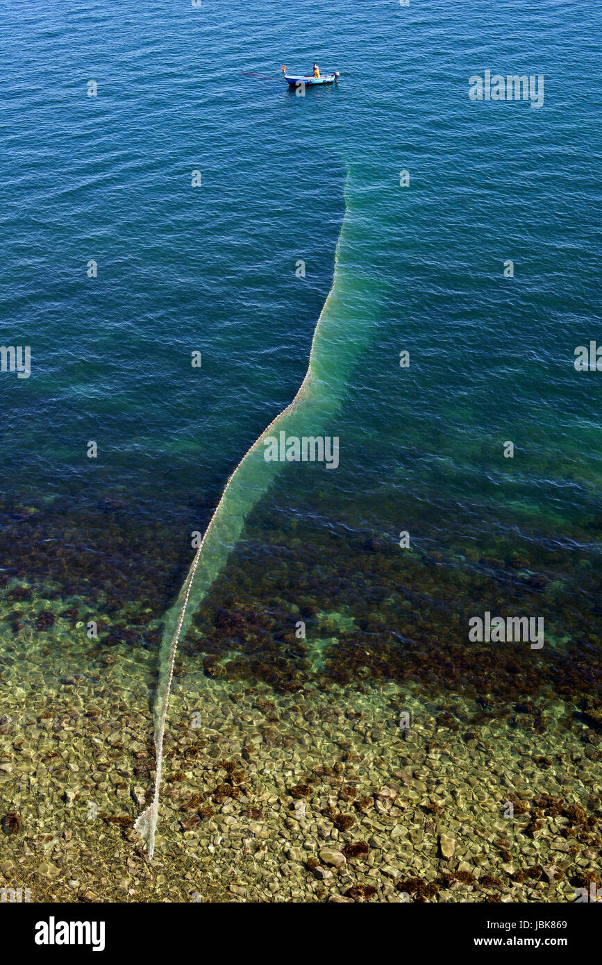 Fisherman lifting fishing net shoot from top Stock Photo - Alamy