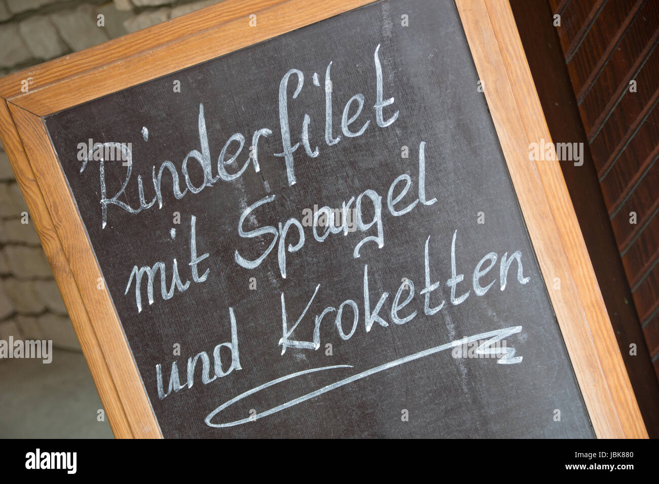 seasonal menu on a chalkboard in German language Stock Photo - Alamy