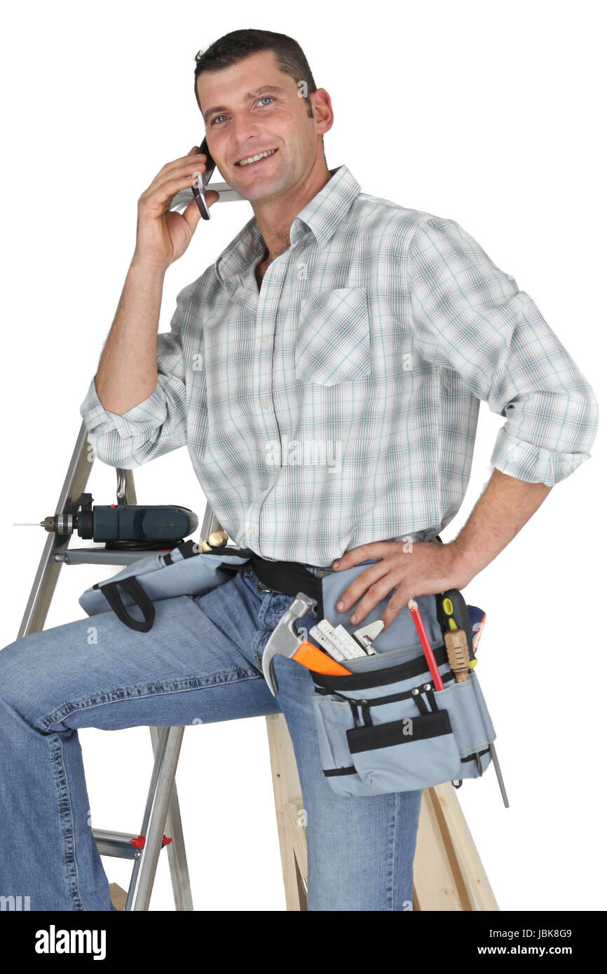 Carpenter posing by ladder Stock Photo - Alamy