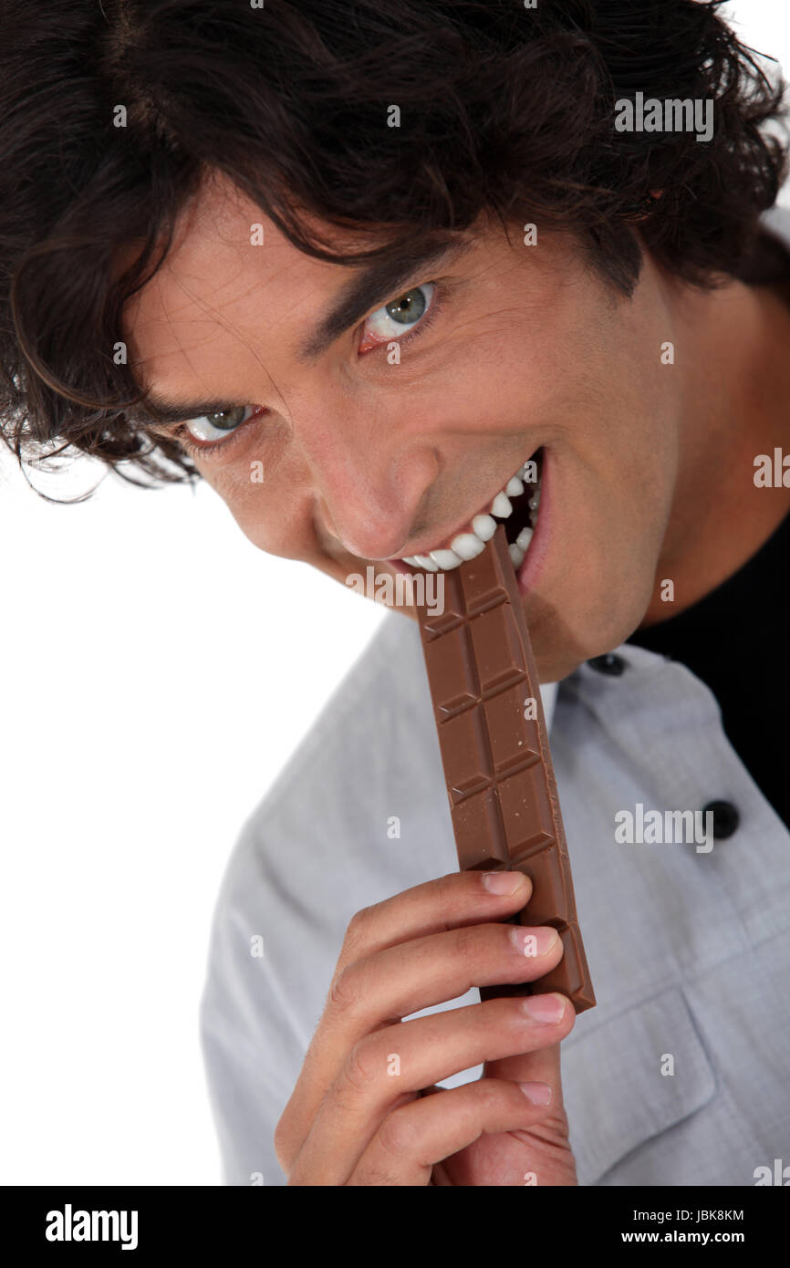 Man eating chocolate Stock Photo - Alamy