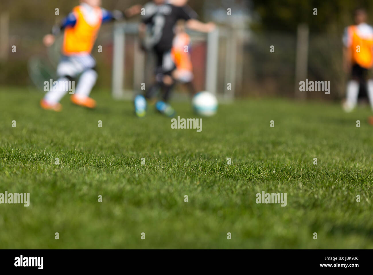 Blurred kids playing soccer on a sunny summer day Stock Photo - Alamy