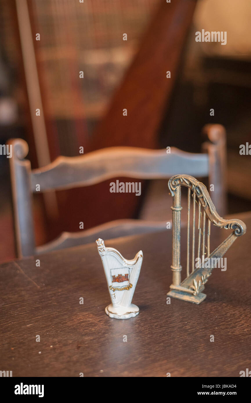 1/4 pictures showing two small ornamental harps on a table in a remote ...