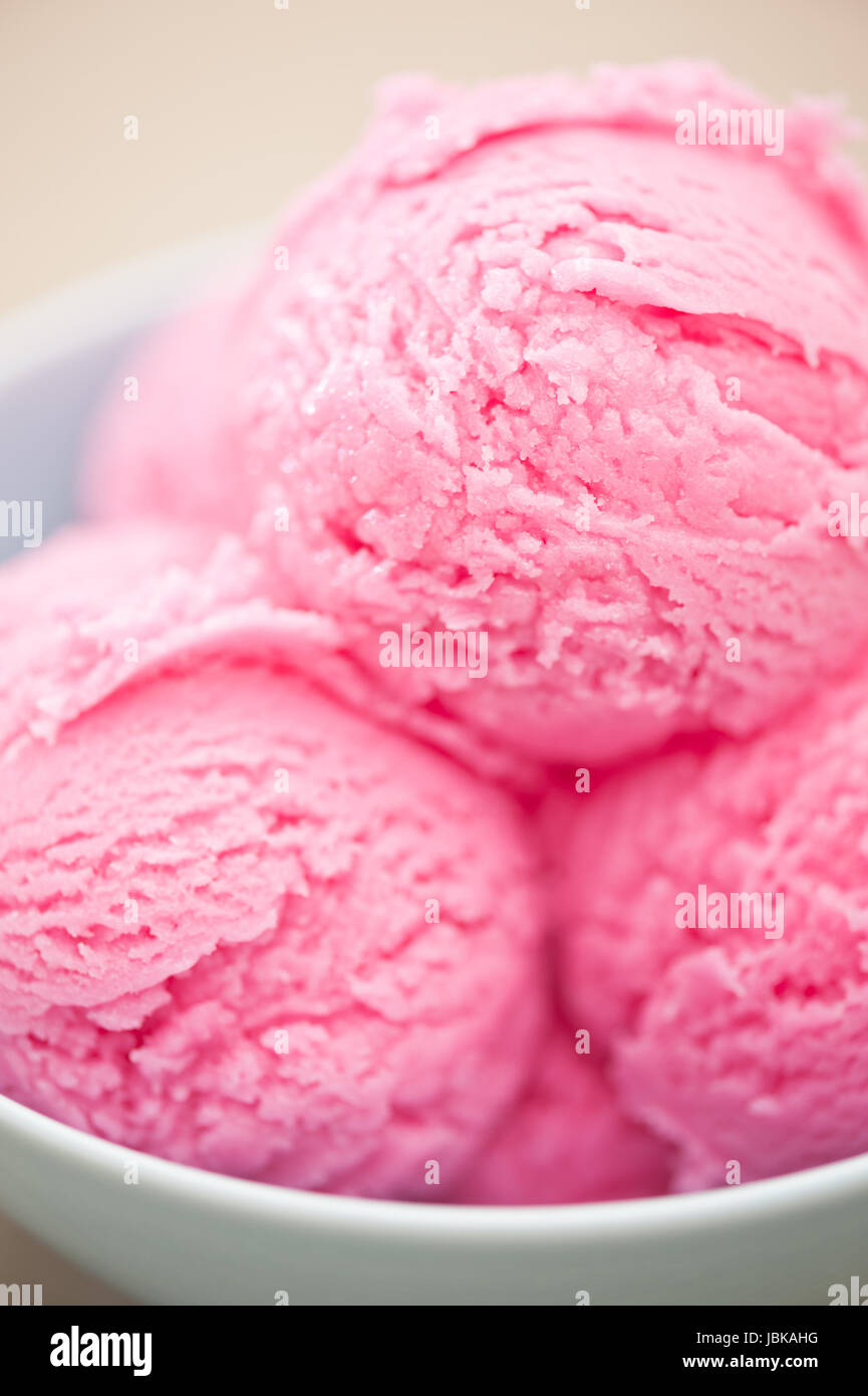 Raspberry ice cream cup over beige background Stock Photo - Alamy