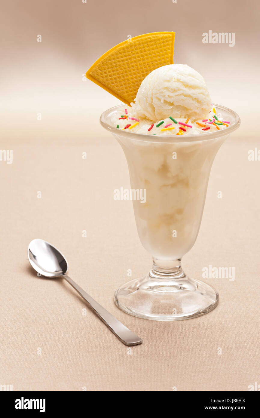 Vanilla ice cream cup with wafer over beige background Stock Photo - Alamy