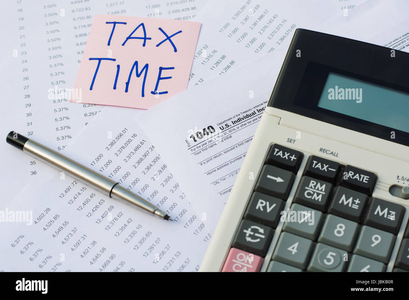 Tax Time written on pink sticker note with on U.S. tax form Stock Photo ...