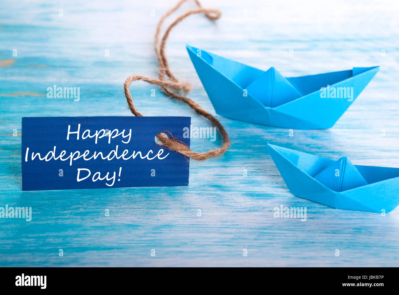A Blue Tag with Happy Independence Day and Boats in the Background ...