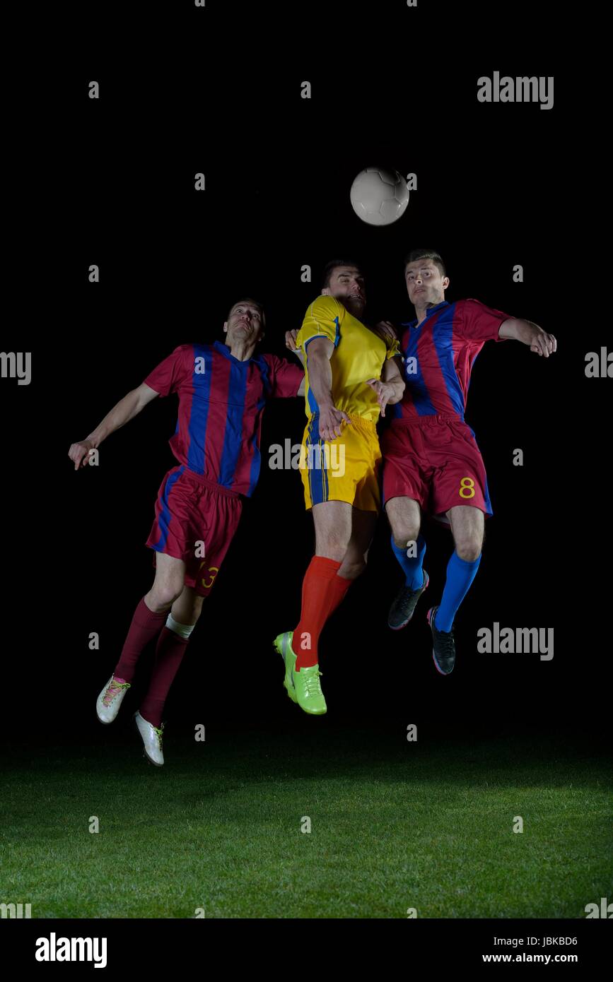 soccer player doing kick with ball on football stadium field isolated ...