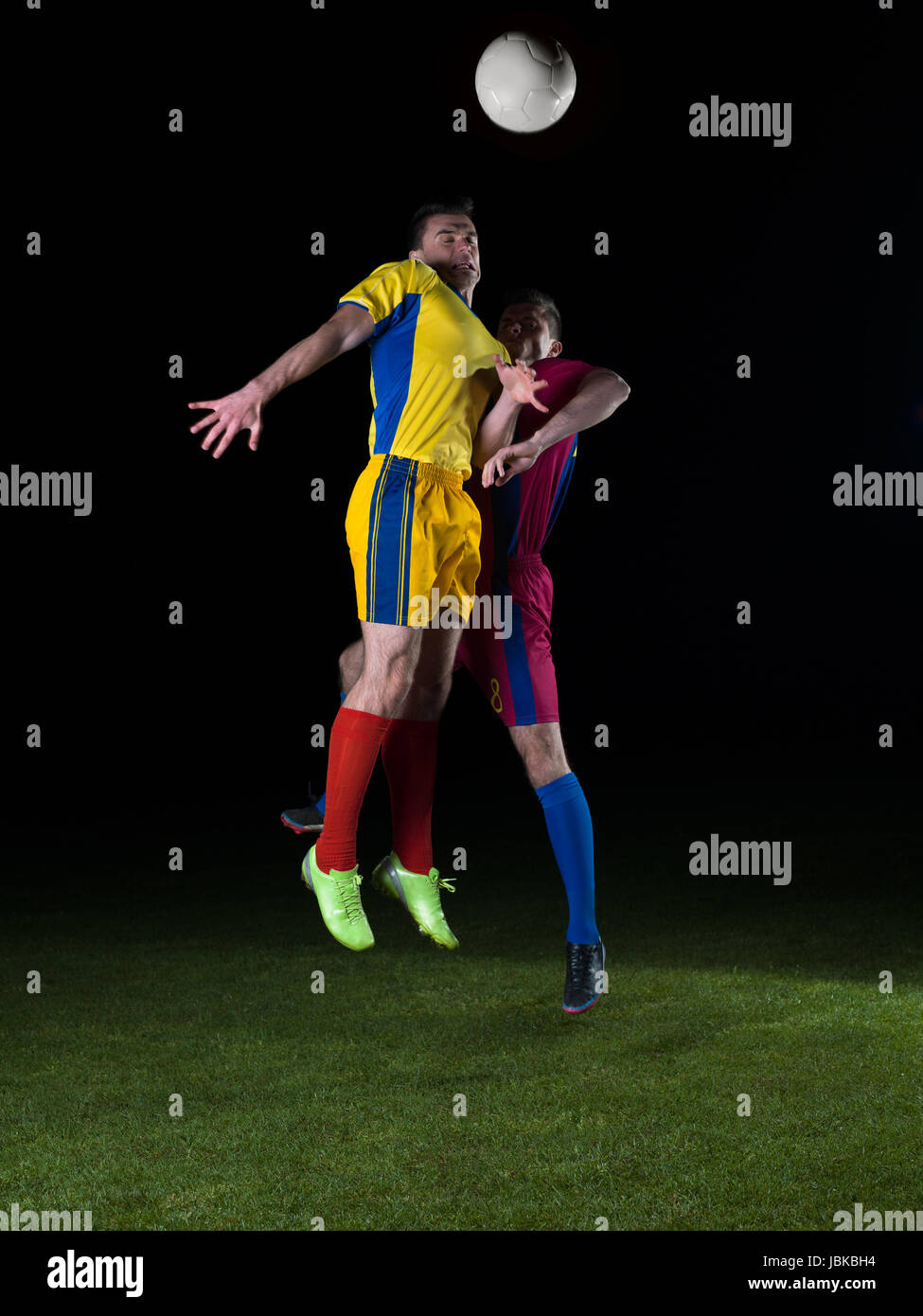 soccer player doing kick with ball on football stadium field isolated ...