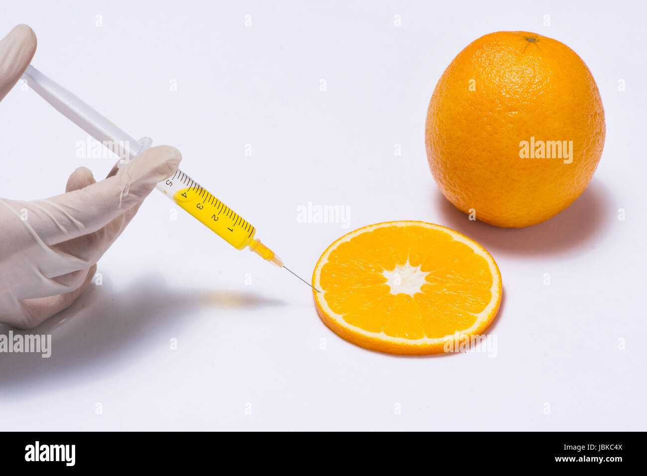 Science experiment with orange and syringe isolated on white Stock ...
