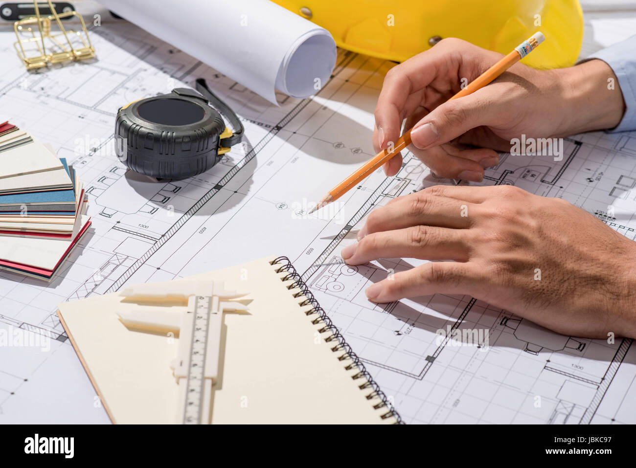 Working on blueprints. Construction project with tools and notebook ...