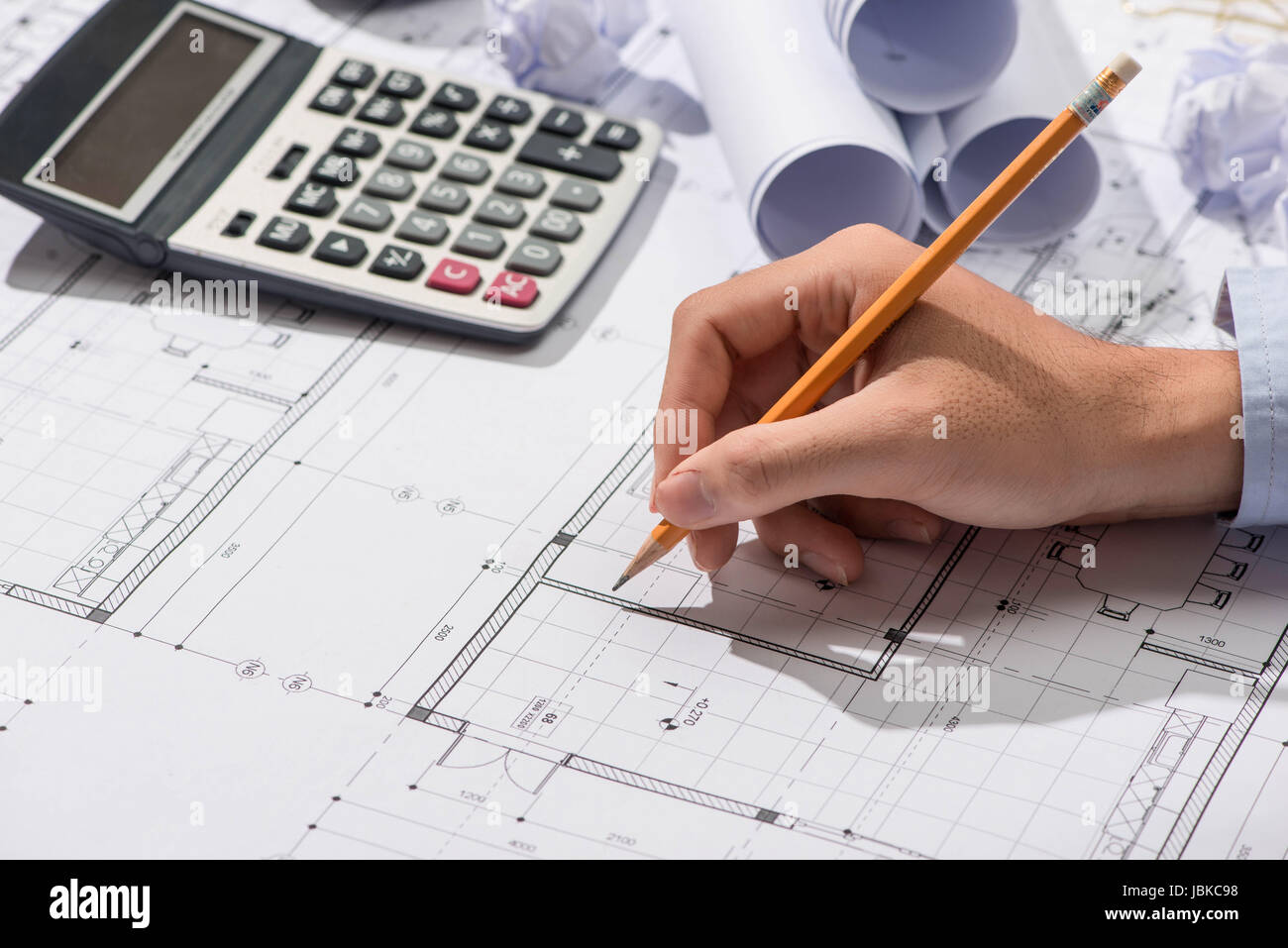 Working on blueprints. Construction project with tools and notebook ...