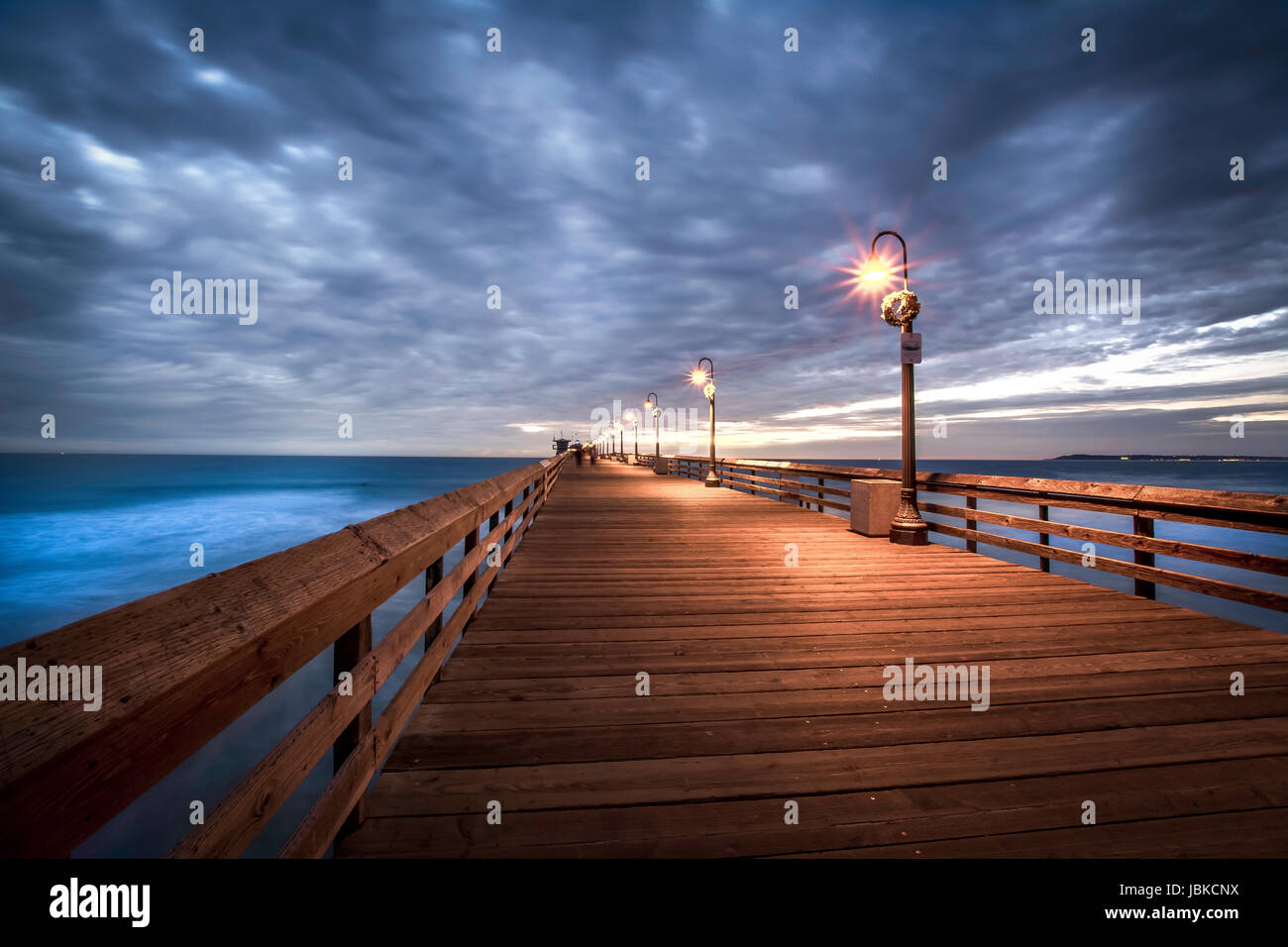 Sunset beach pier surfer hi-res stock photography and images - Alamy
