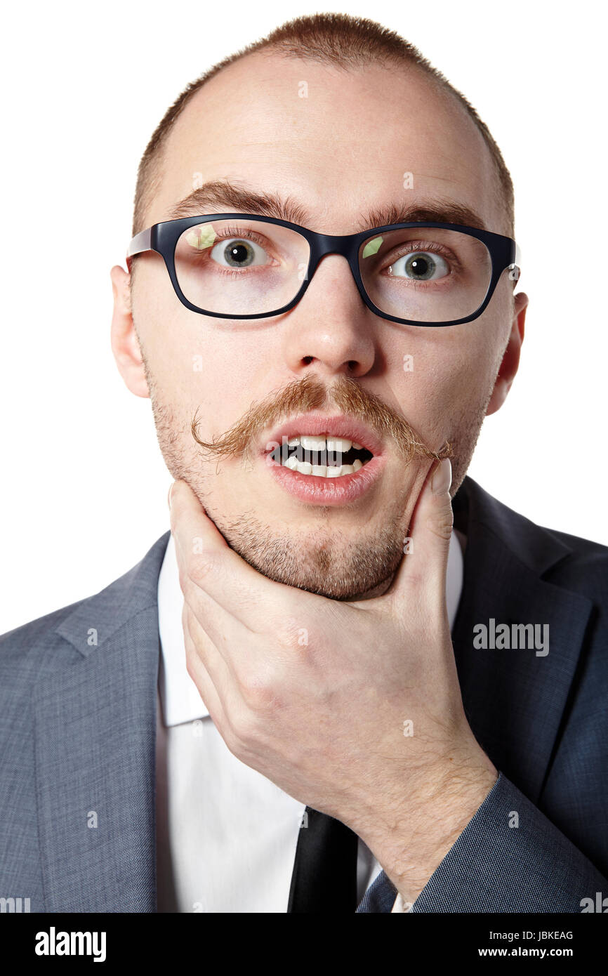 Studio shot of young man holding his chin. Facial expression Stock ...