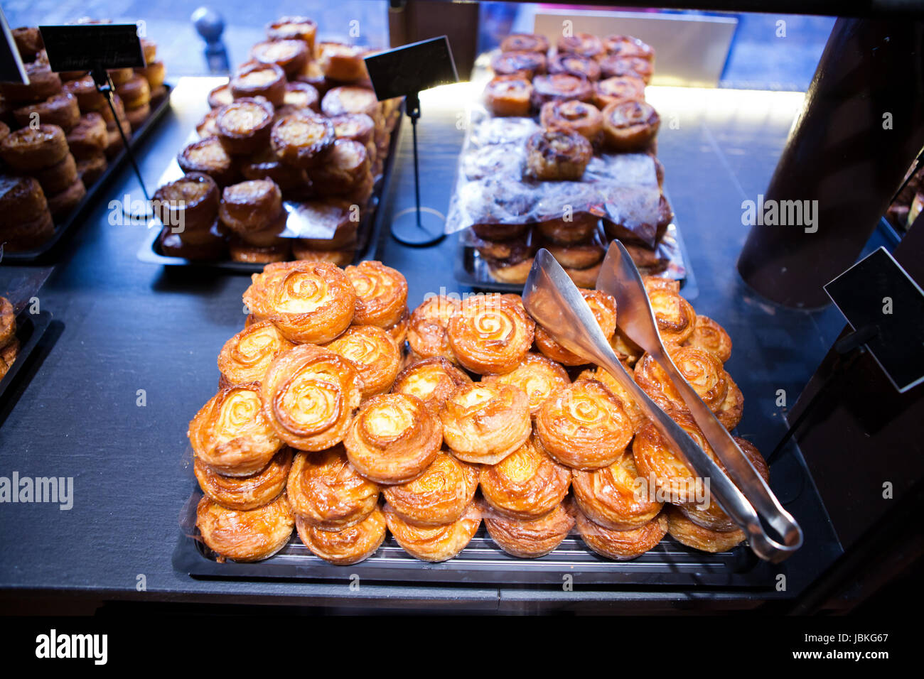 Closeup of mix of various sweet buns on display trays at cafe Stock ...