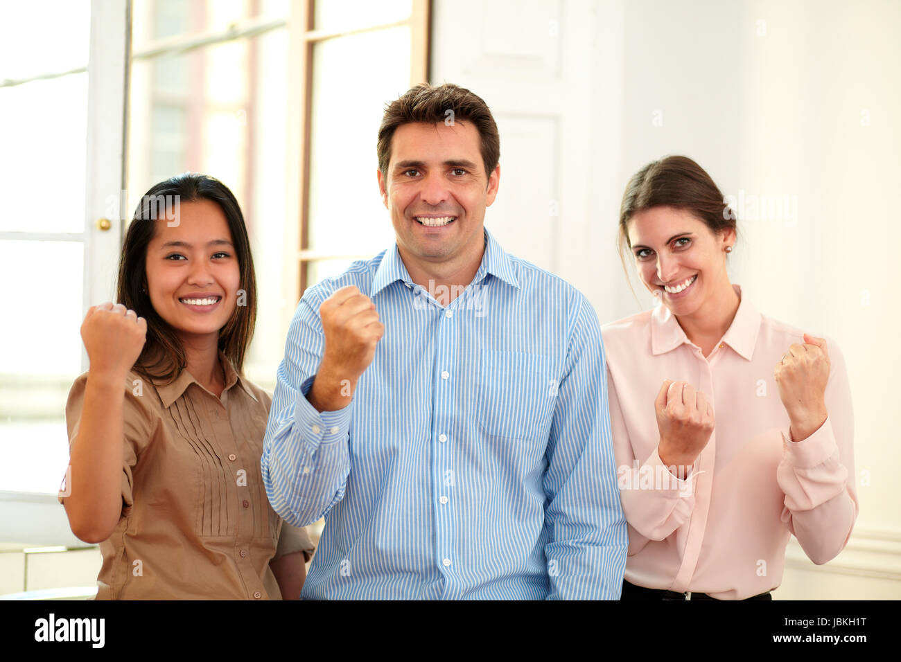 Portrait of charming professional team with winning sign smiling at you ...