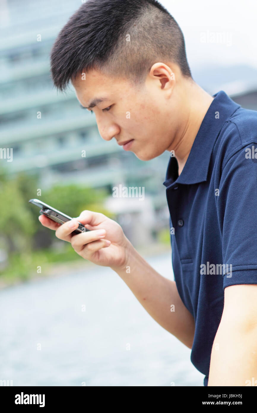 man checking his phone outdoor Stock Photo - Alamy