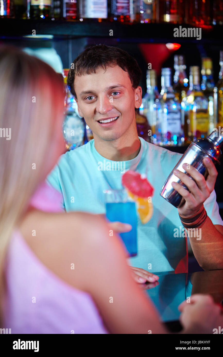 Portrait of smiling male with bottle looking at girl in the bar Stock ...