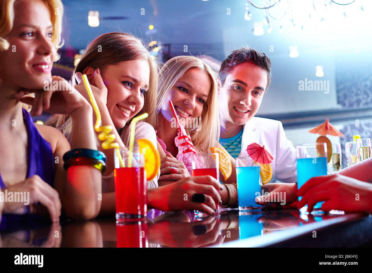 Portrait of happy friends with cocktails having rest in bar Stock Photo ...