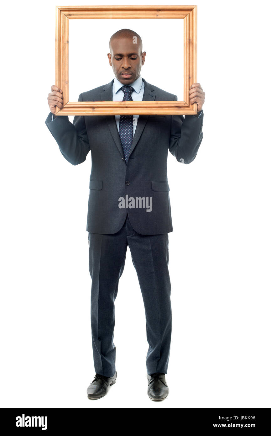 Middle aged man standing behind wooden picture frame Stock Photo - Alamy