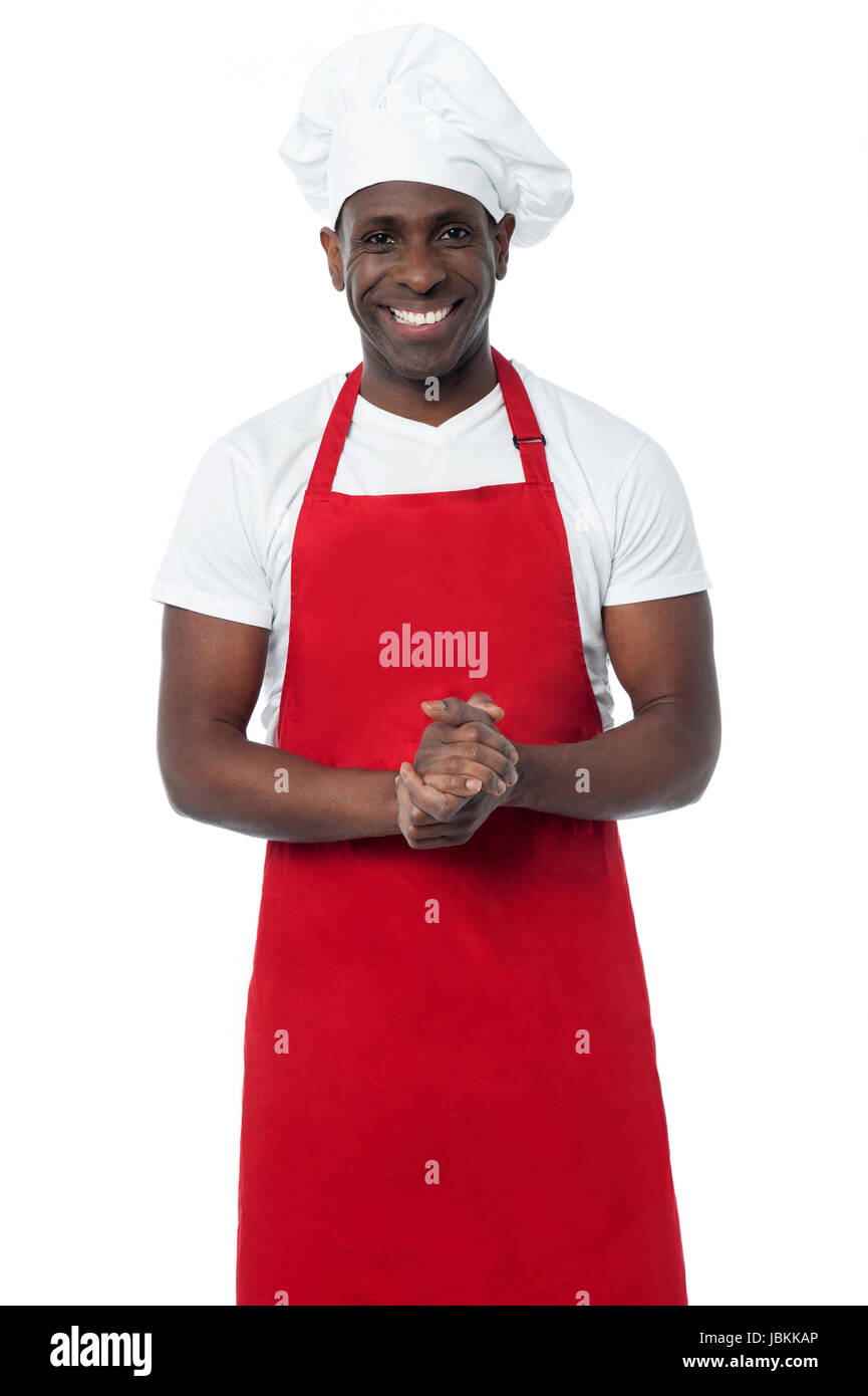 Male chef standing with his hands clasped and smiling Stock Photo - Alamy