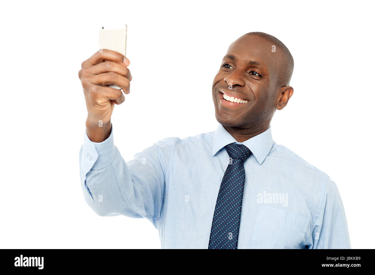 Corporate guy looking his mobile phone Stock Photo - Alamy