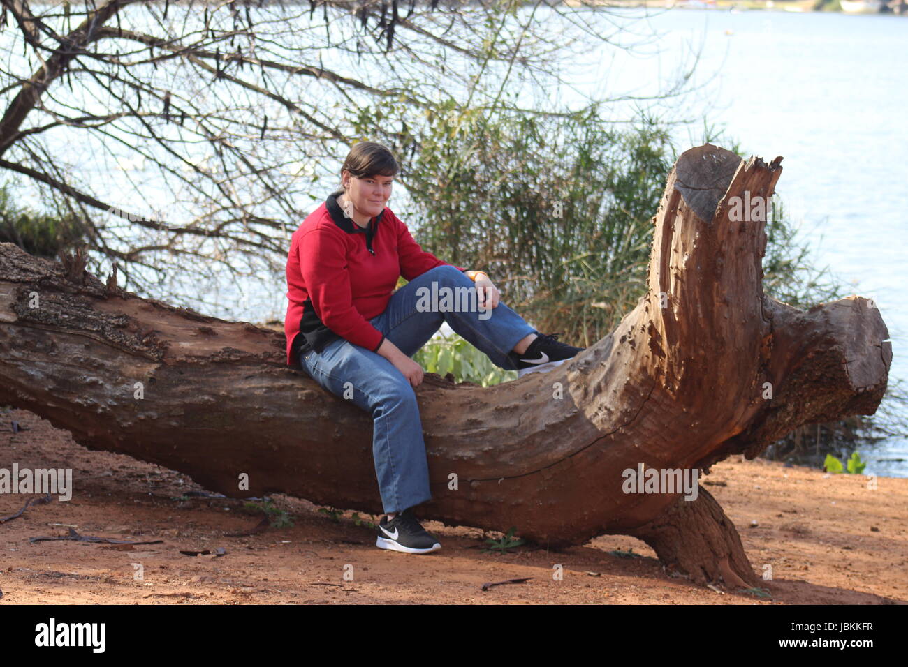 girl on log Stock Photo - Alamy