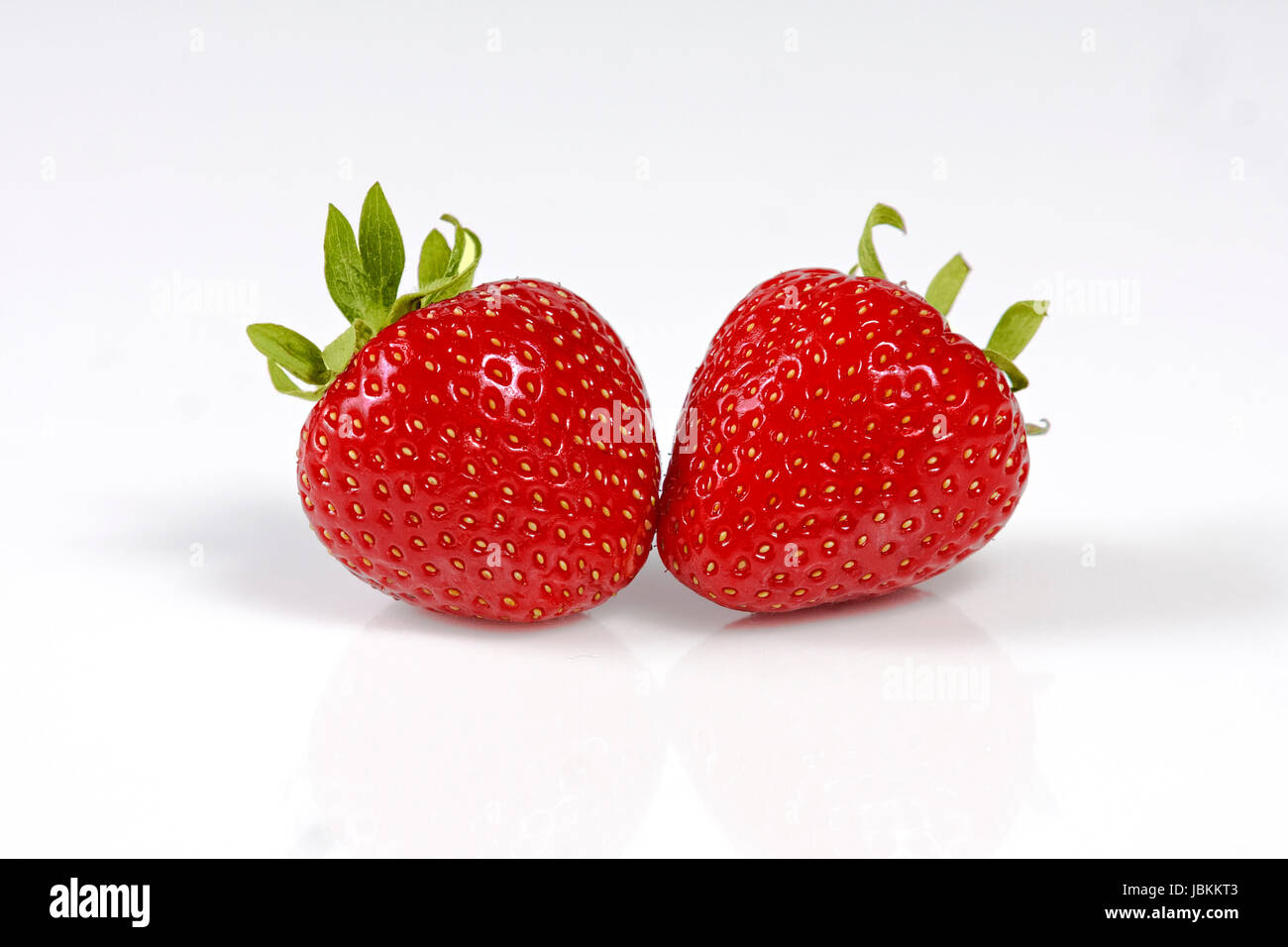 Two red strawberrys isolated on white background Stock Photo - Alamy