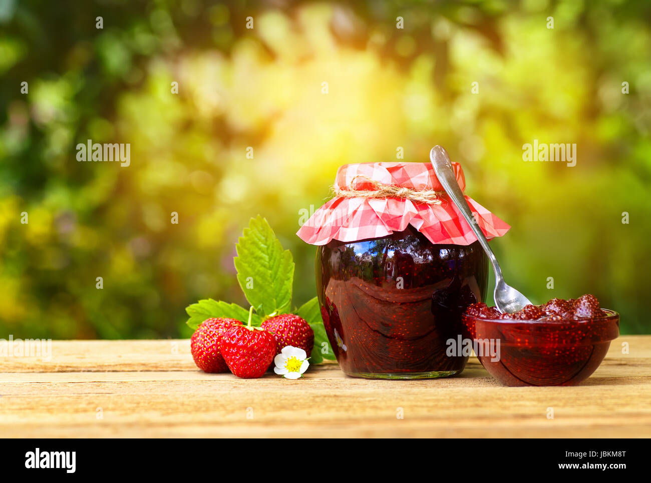 still life with strawberry jam on table with sunshine blurred natural ...