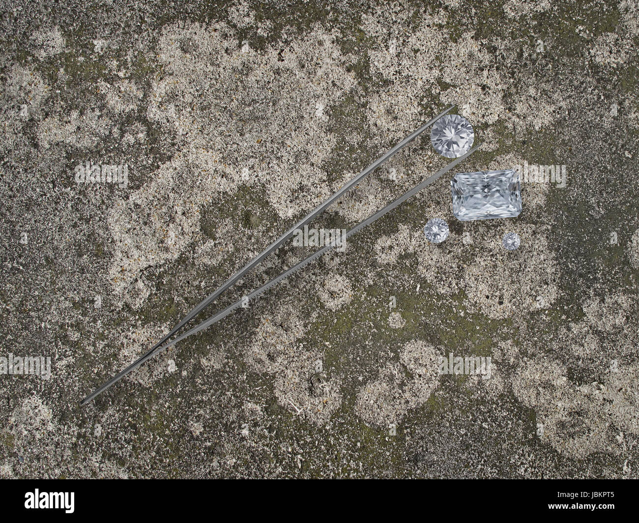 various cut cluster of diamonds on an old cement Stock Photo - Alamy