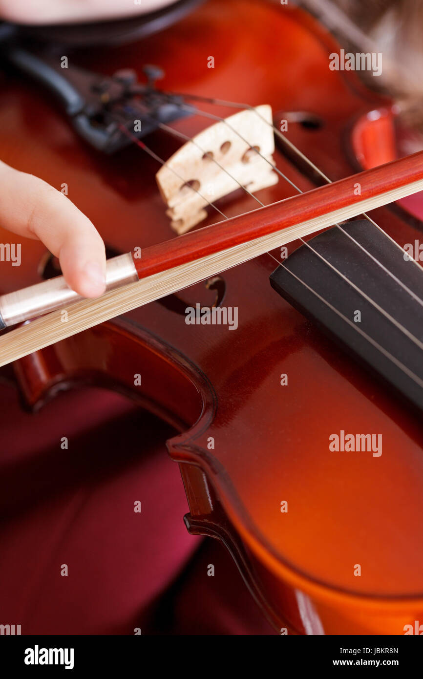 girl playing violin - strings and bow close up Stock Photo - Alamy