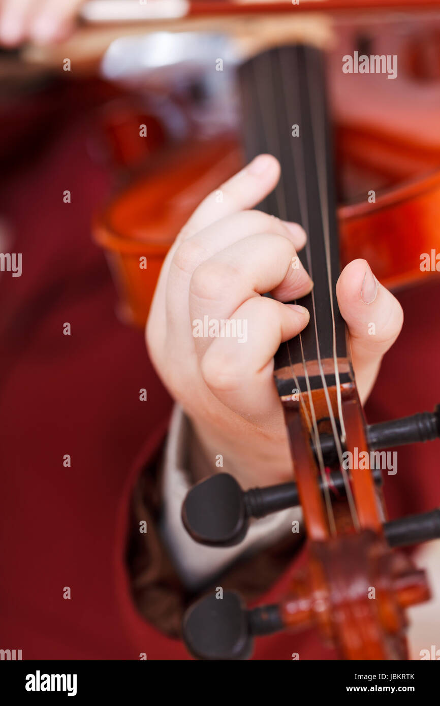 girl playing fiddle - chord on fingerboard close up Stock Photo - Alamy