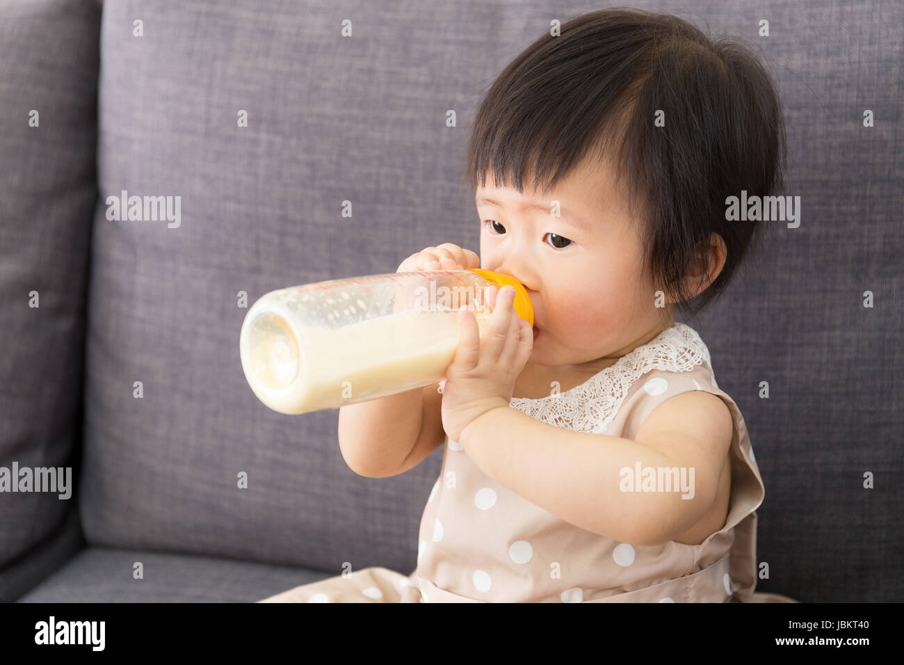 Asia baby girl feeding with milk bottle Stock Photo - Alamy
