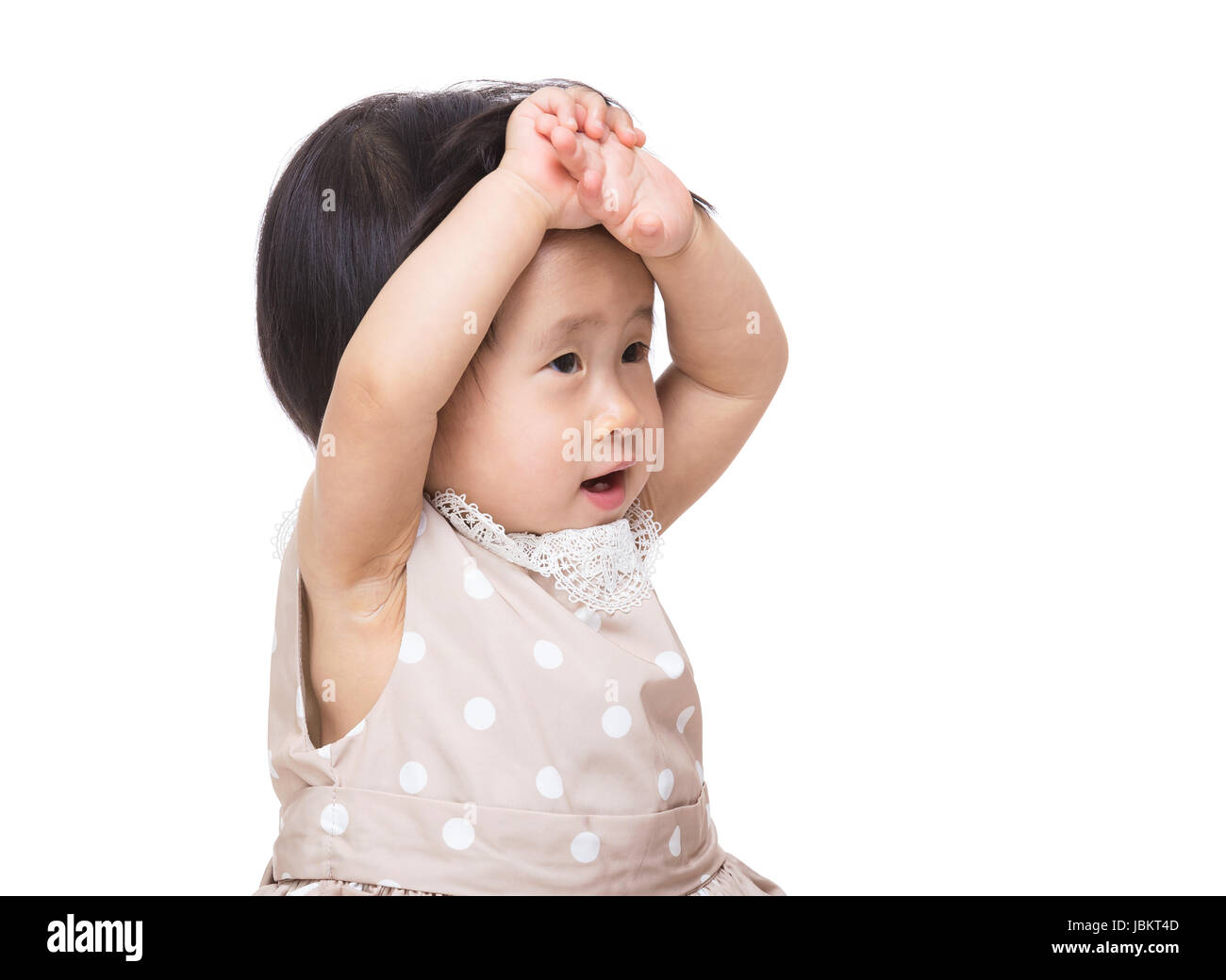 Asian baby girl touching her head Stock Photo - Alamy