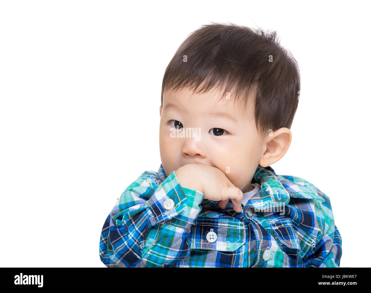 Asian baby boy bite his hand Stock Photo - Alamy
