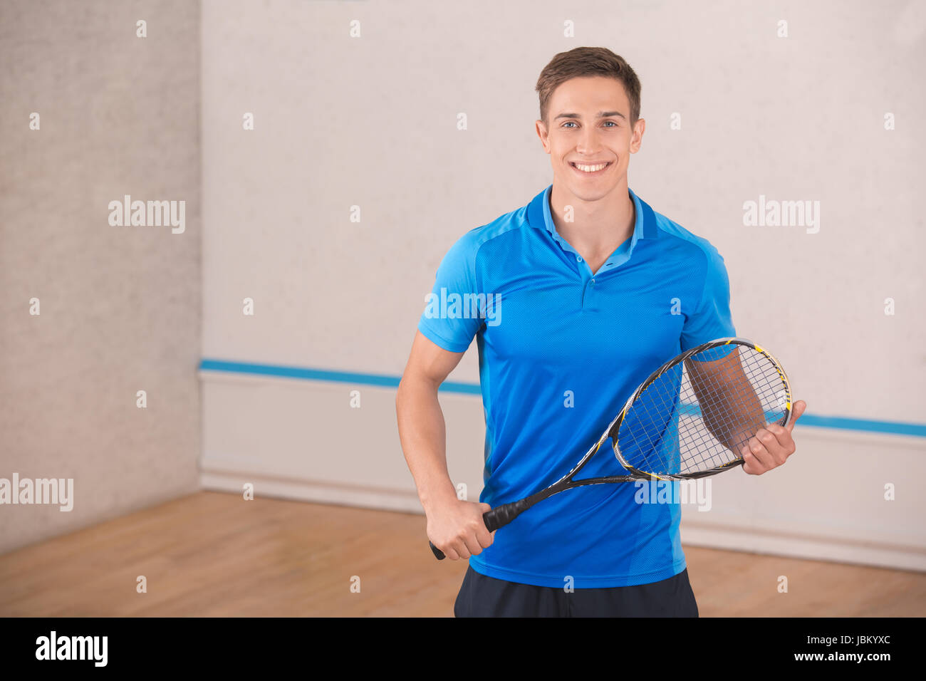 Young man squash player exercise game in the gym Stock Photo - Alamy
