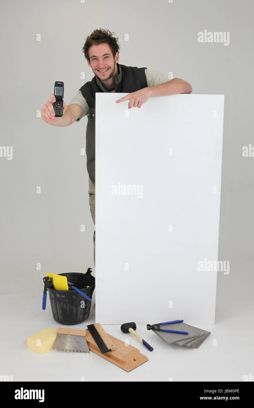 Decorator displaying mobile phone Stock Photo - Alamy