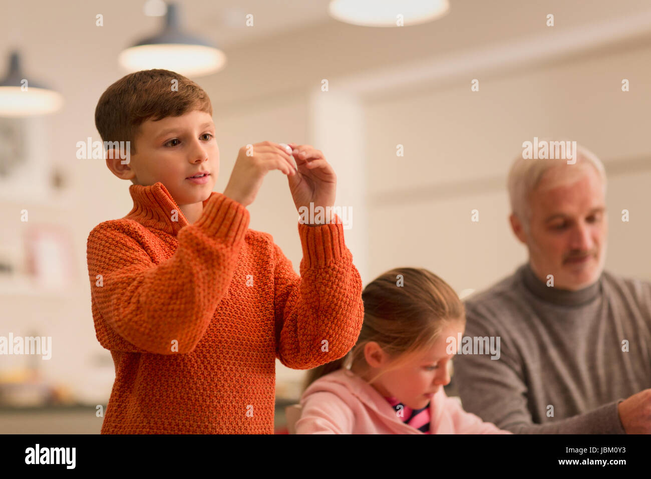 Curious boy holding gadget Stock Photo - Alamy