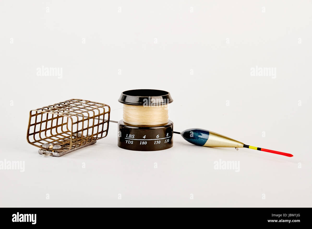 Metal feeder, spool and float Stock Photo - Alamy