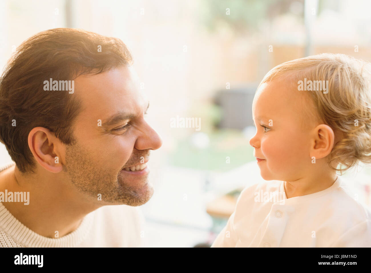 Father smiling at cute baby son Stock Photo - Alamy