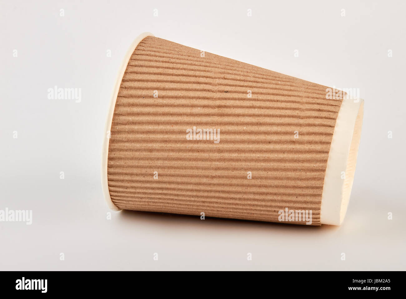 Empty paper cup lying on white Stock Photo - Alamy