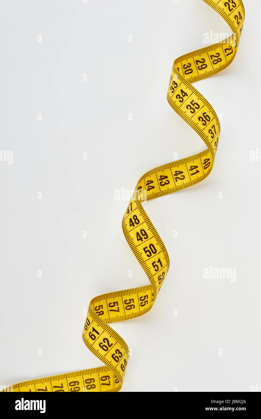 Yellow swirly measuring tape Stock Photo - Alamy