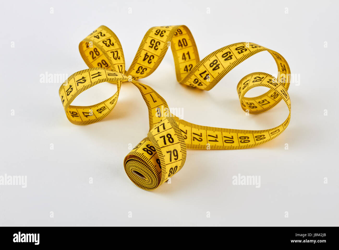 Closeup yellow measuring tape Stock Photo - Alamy