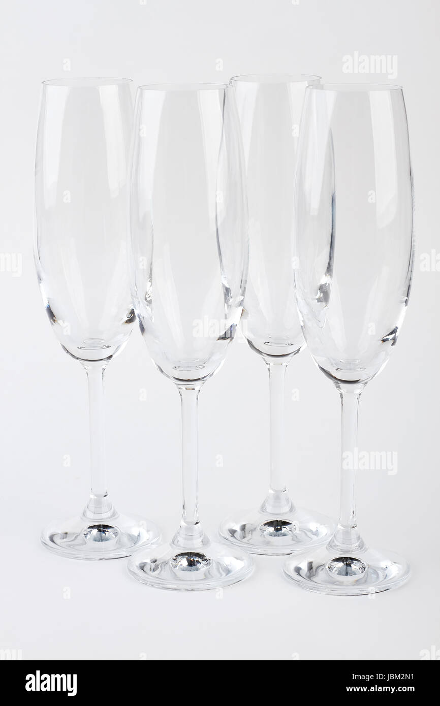 Four fragile champagne glasses isolated Stock Photo - Alamy