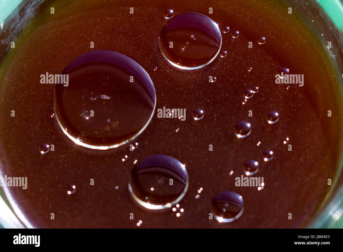 close up of a few drops of coconut oil floating on top of a morning cup ...