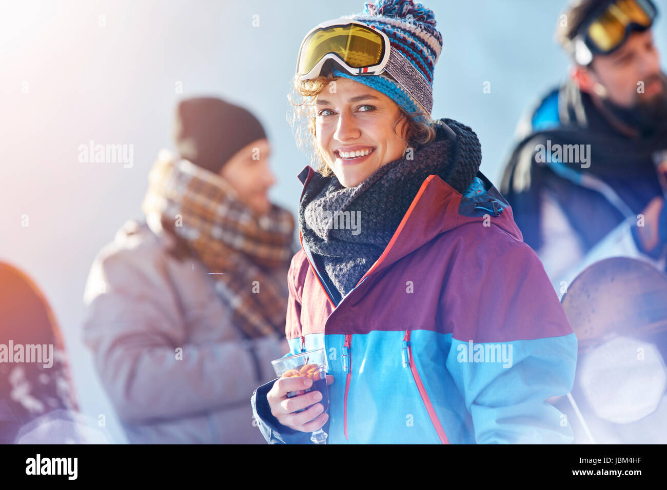 Portrait smiling female skier drinking cocktail Stock Photo - Alamy