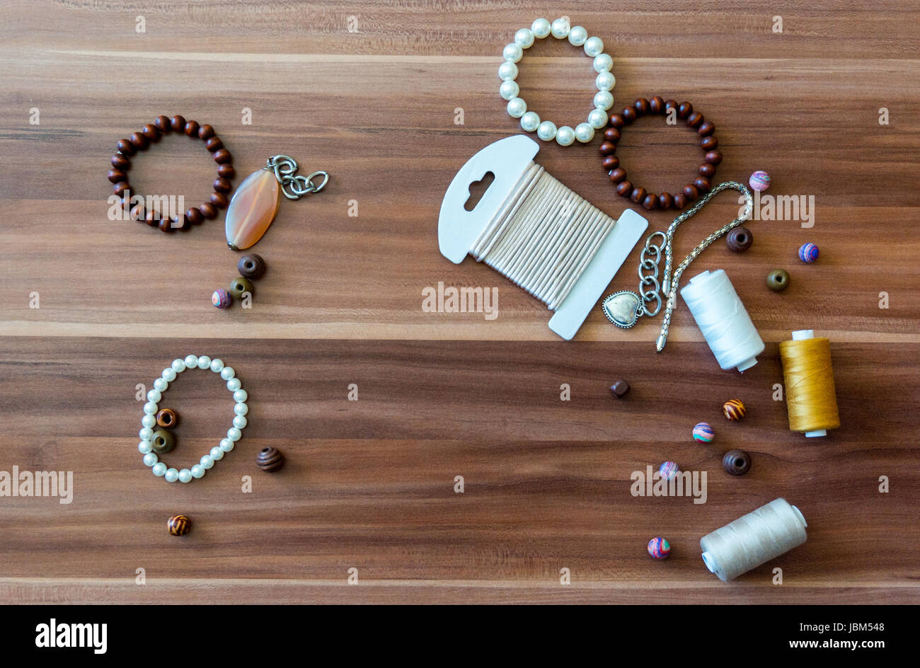 Beads, pearls, thread and string for handcrafting Stock Photo - Alamy
