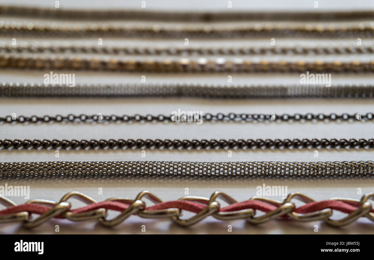 Rows of different chains with white background Stock Photo - Alamy